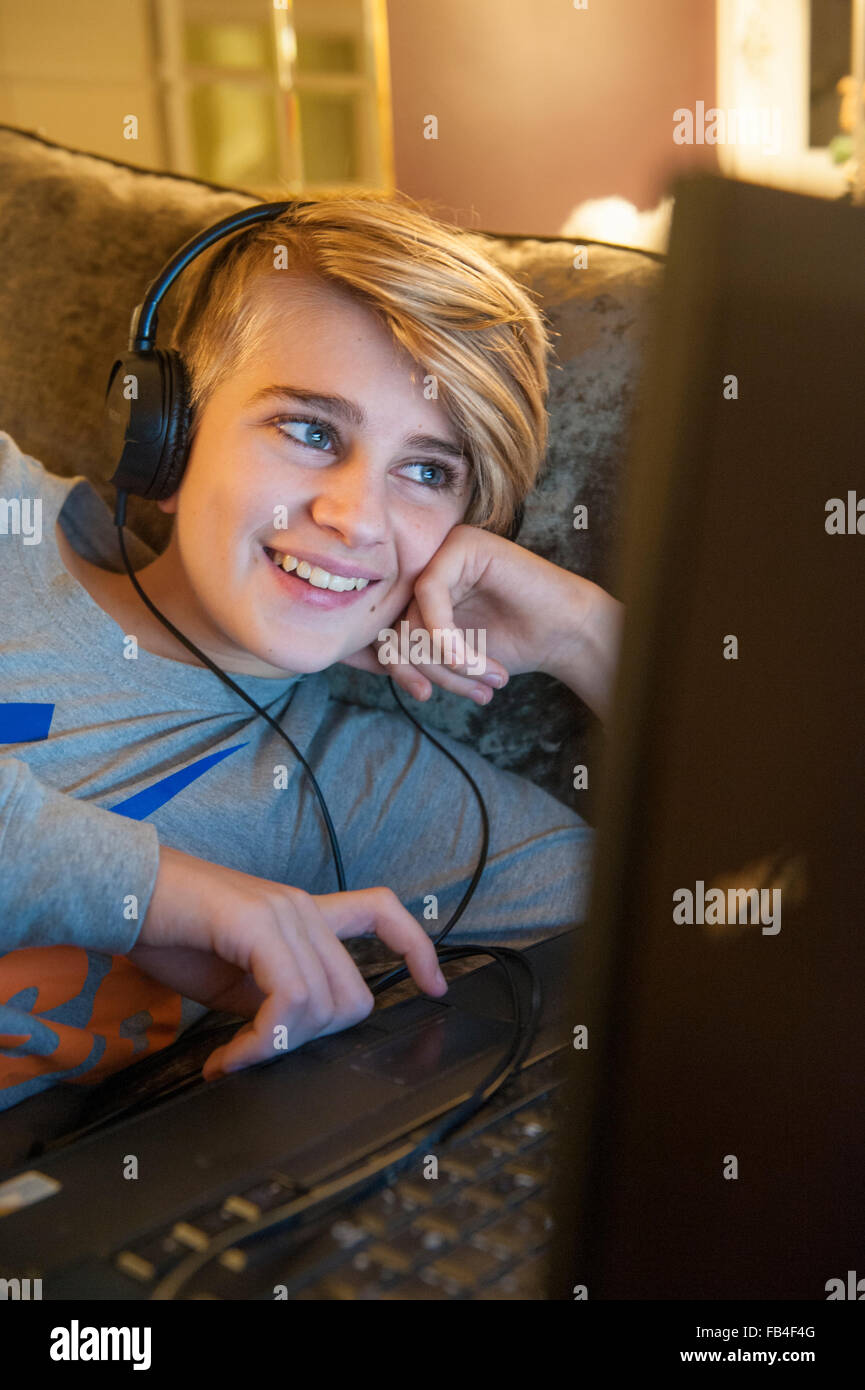 A young boy plays on his laptop computer Stock Photo - Alamy