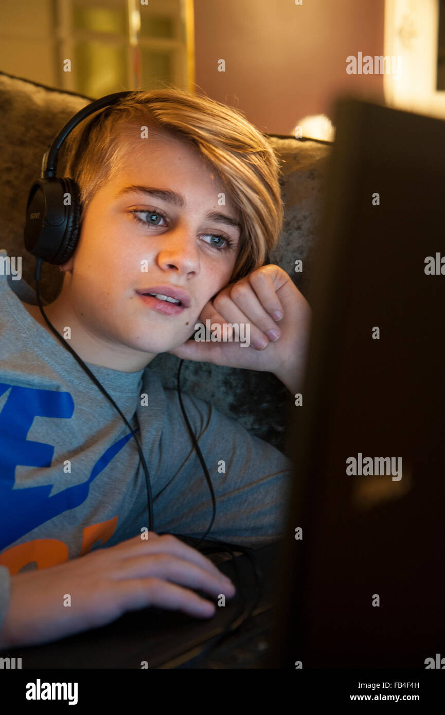 A young boy plays on his laptop computer Stock Photo - Alamy