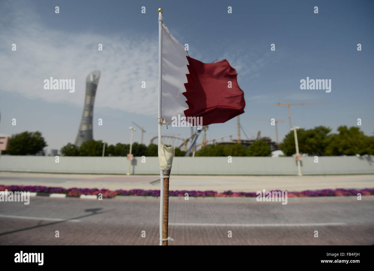 A Qatari flag flies in front of the construction site of the Khalifa ...