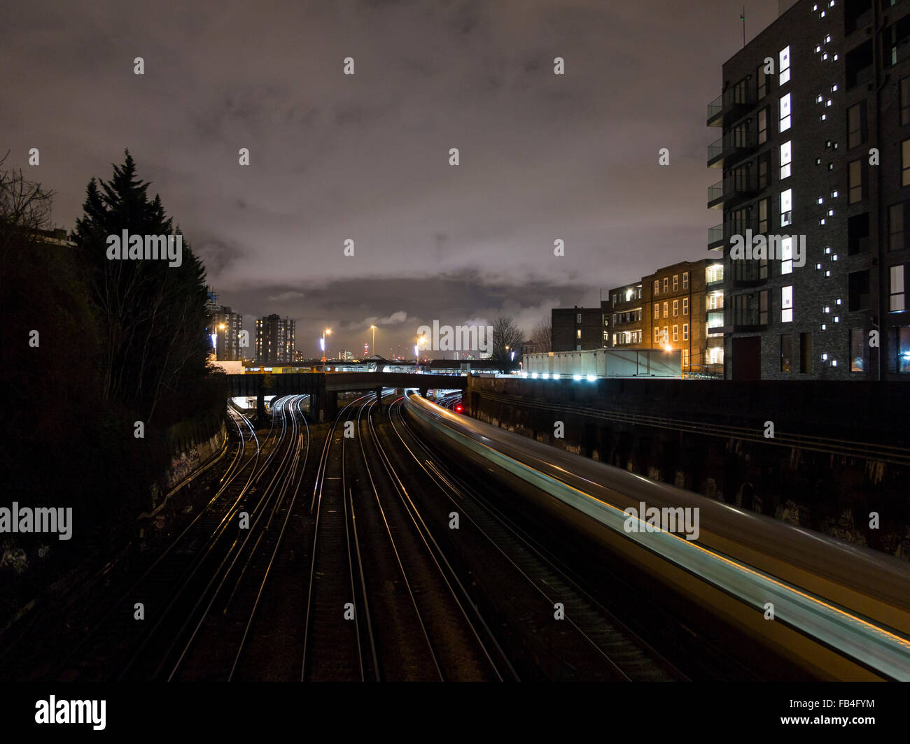 Blurred trains at Clapham Junction station at night Stock Photo - Alamy