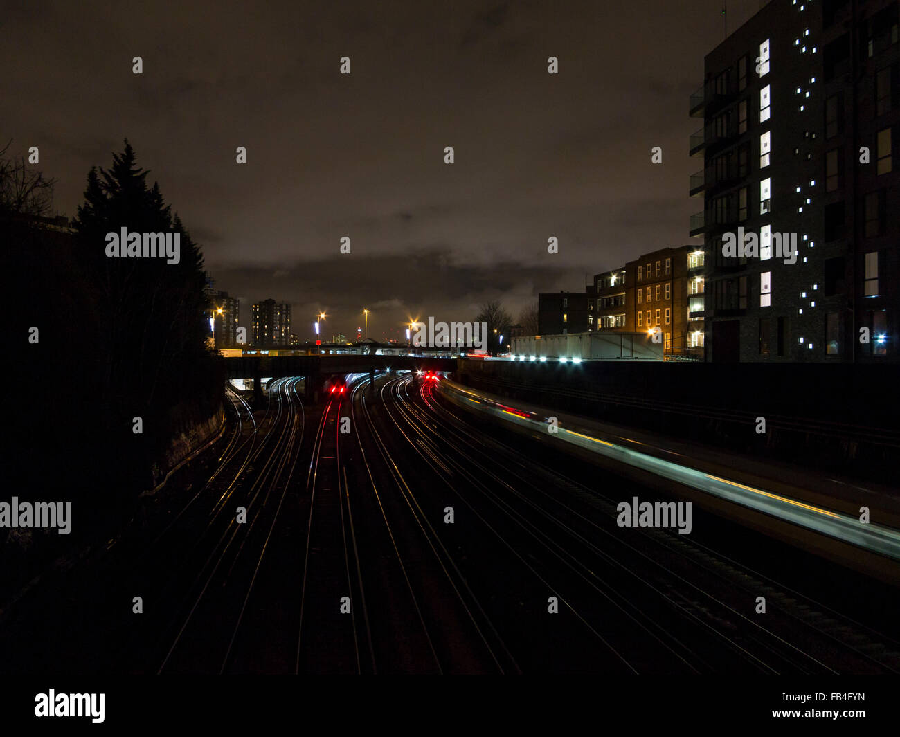 Blurred trains at Clapham Junction station at night Stock Photo - Alamy