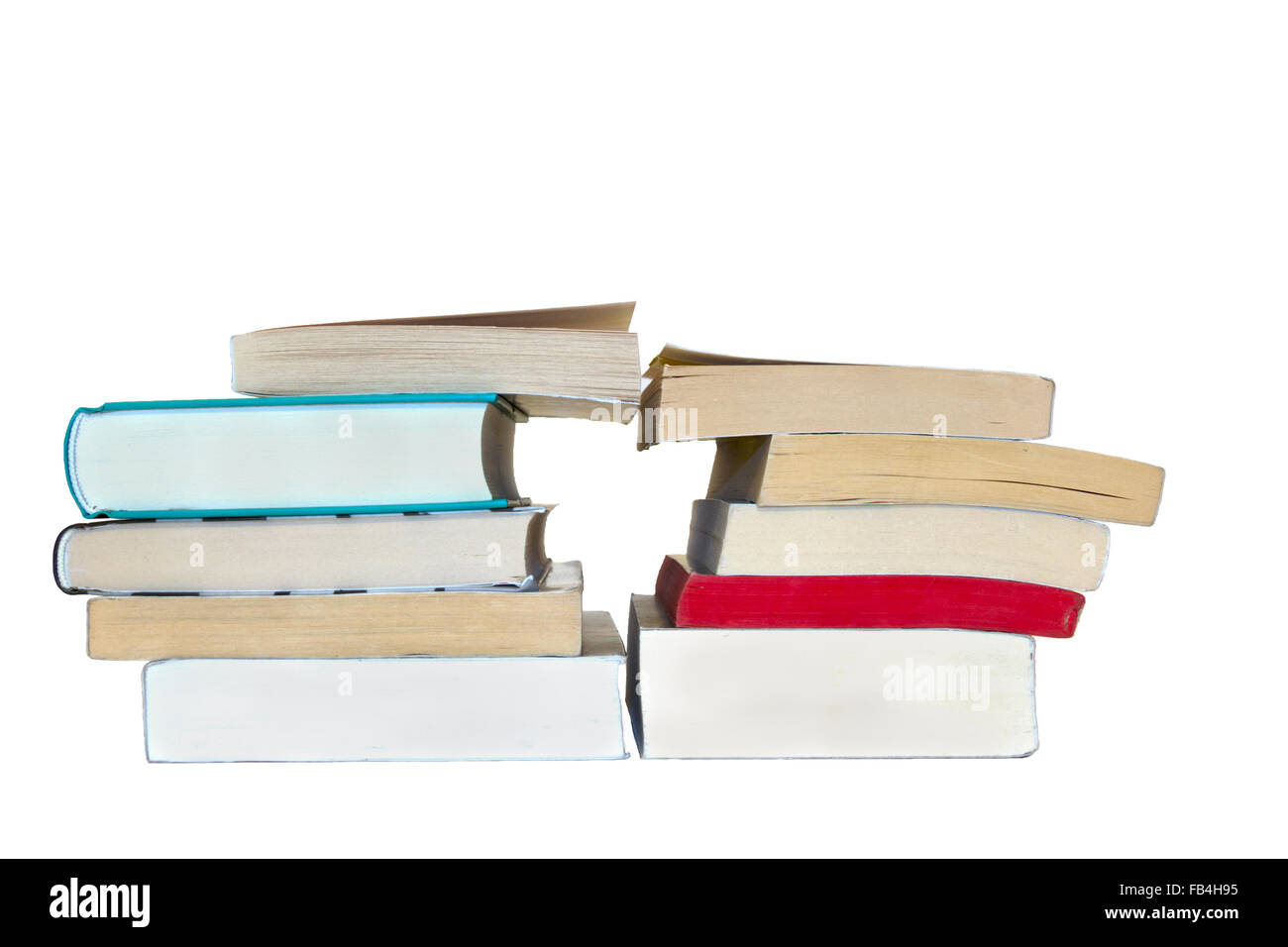 Two piles of books with a triangle in the middle, isolated over white ...