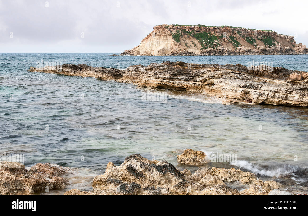 Rocky Seascape with the small island of geronisos st. georges cape at ...