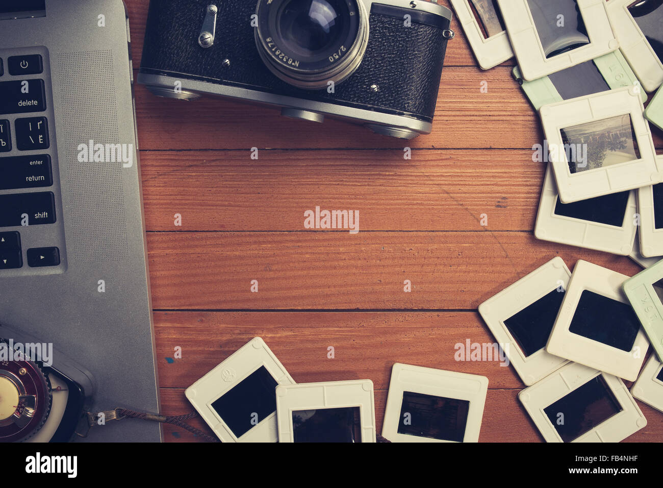 composition of old fashioned photo camera, laptop and photo slides on ...