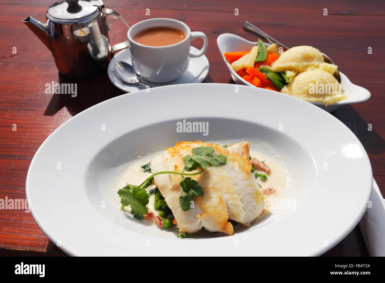 fish dish and black English tea Stock Photo - Alamy