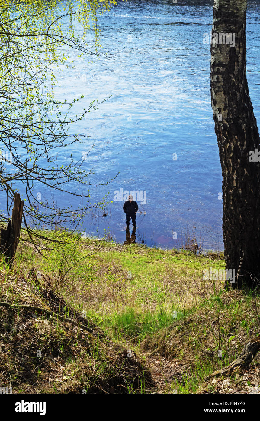 Spring river landscape with young man on coast Stock Photo - Alamy