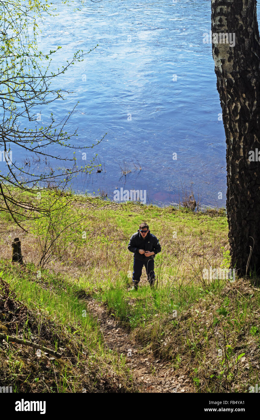 Spring river landscape with young man on coast Stock Photo - Alamy