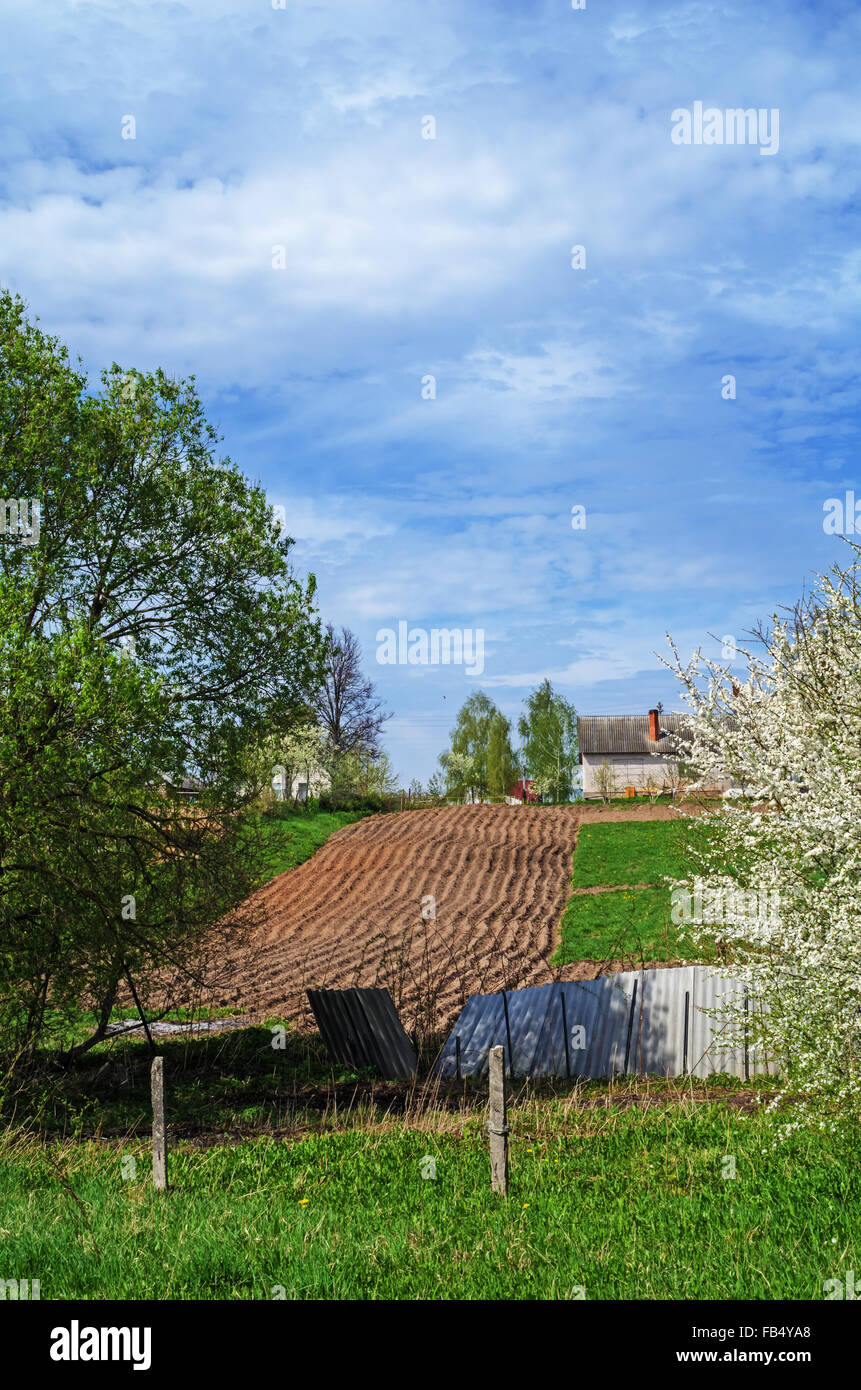Spring village landscape. Garden Stock Photo - Alamy