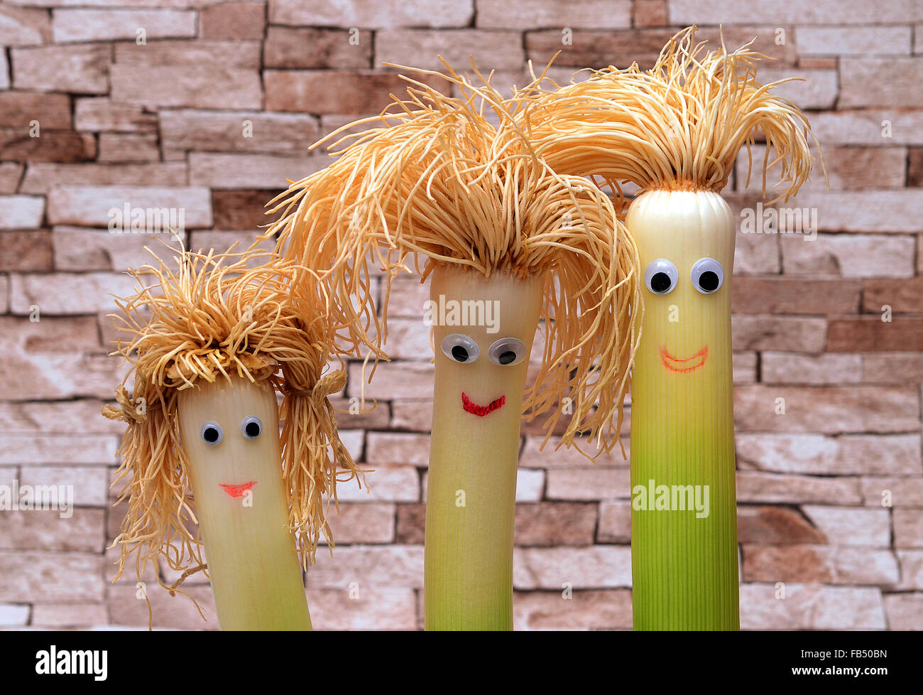 Three leeks with faces, symbolic picture for healthy vegetables Stock ...
