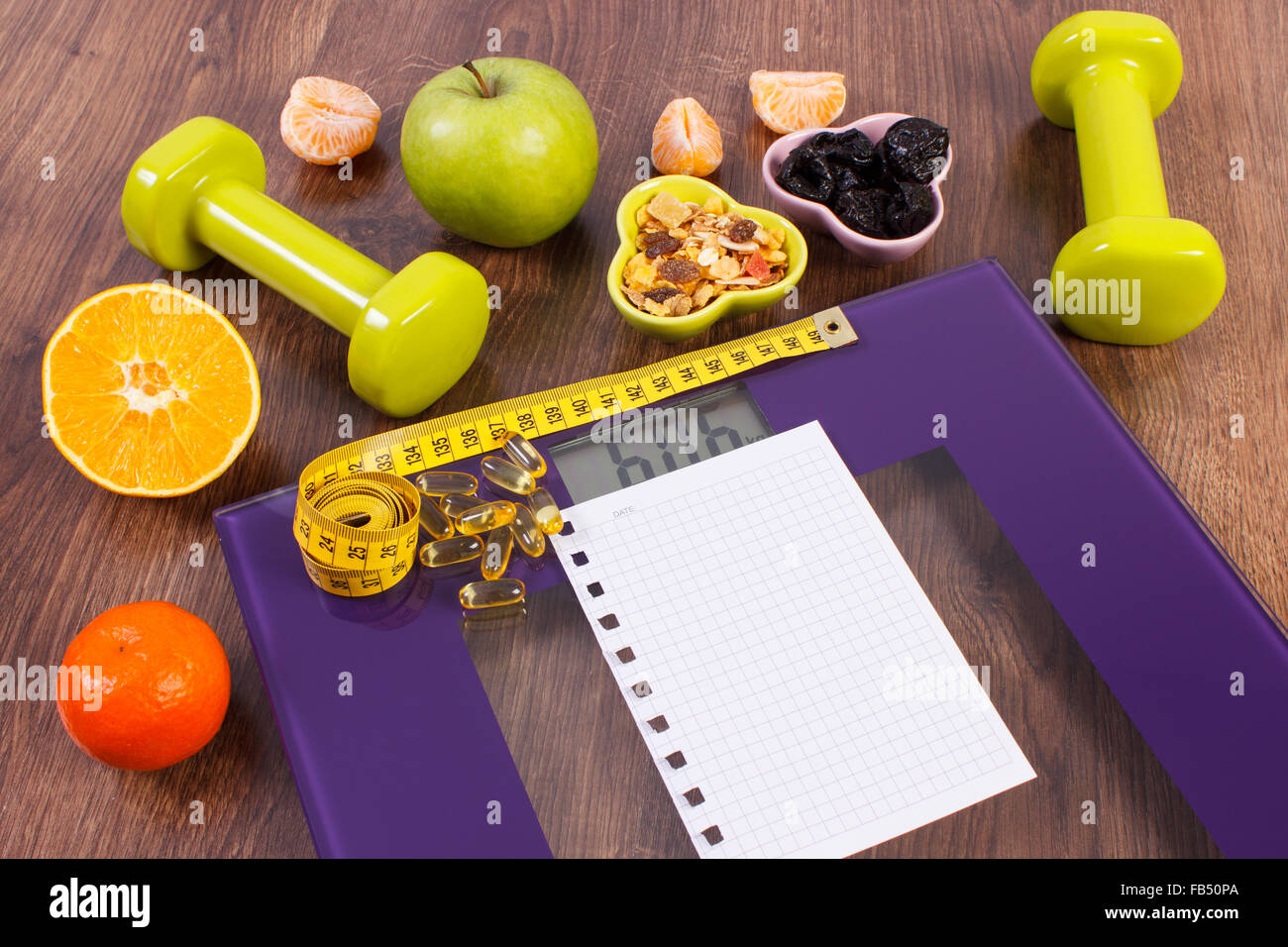 Tape measure, tablets supplements on digital bathroom scale for weight ...