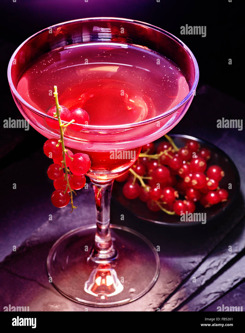 Red currant cocktail on black background Stock Photo - Alamy