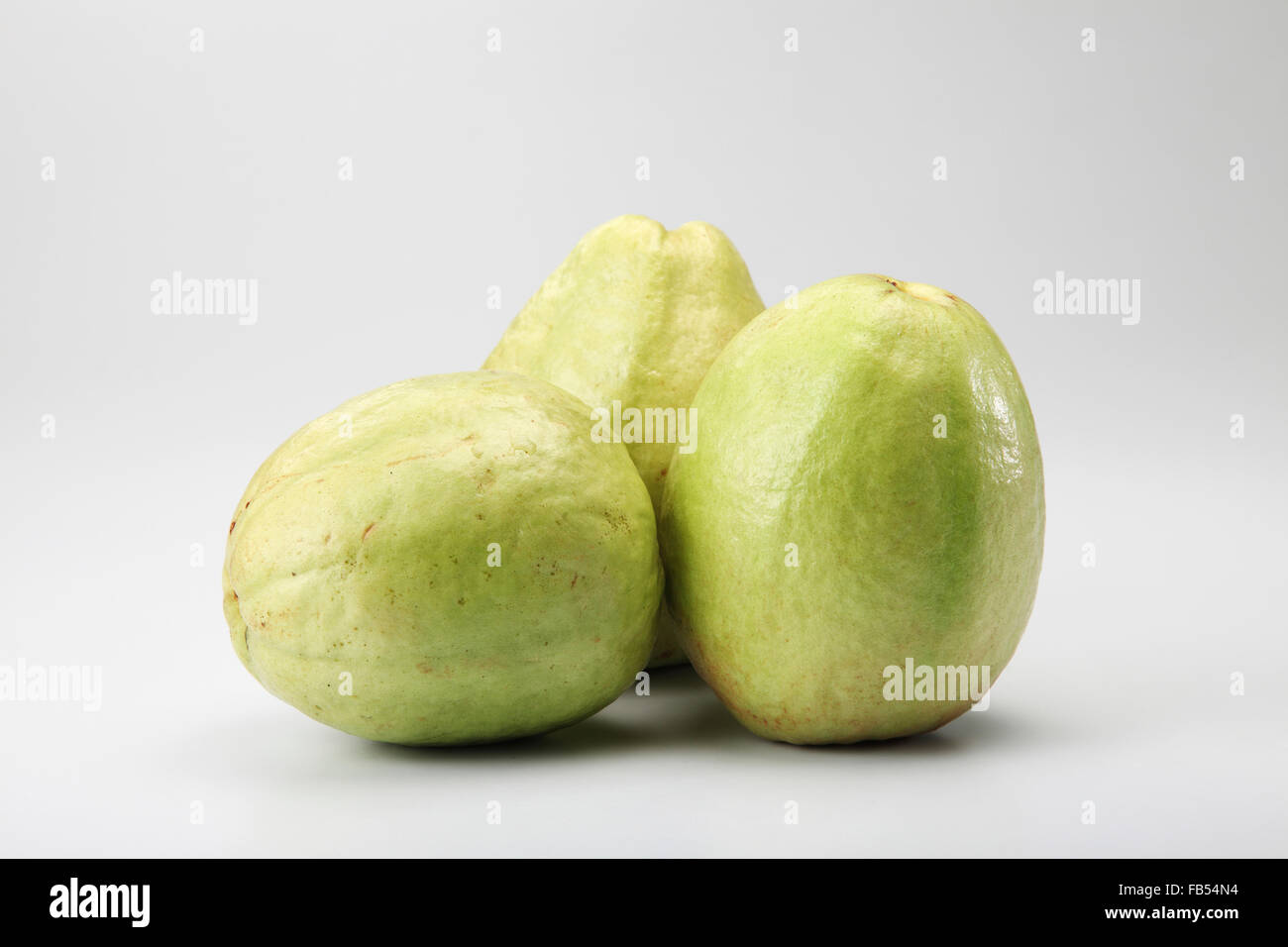three guava on the plain background Stock Photo - Alamy