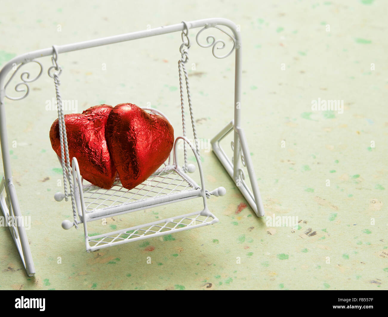 two heart shape chocolate on the swing Stock Photo - Alamy