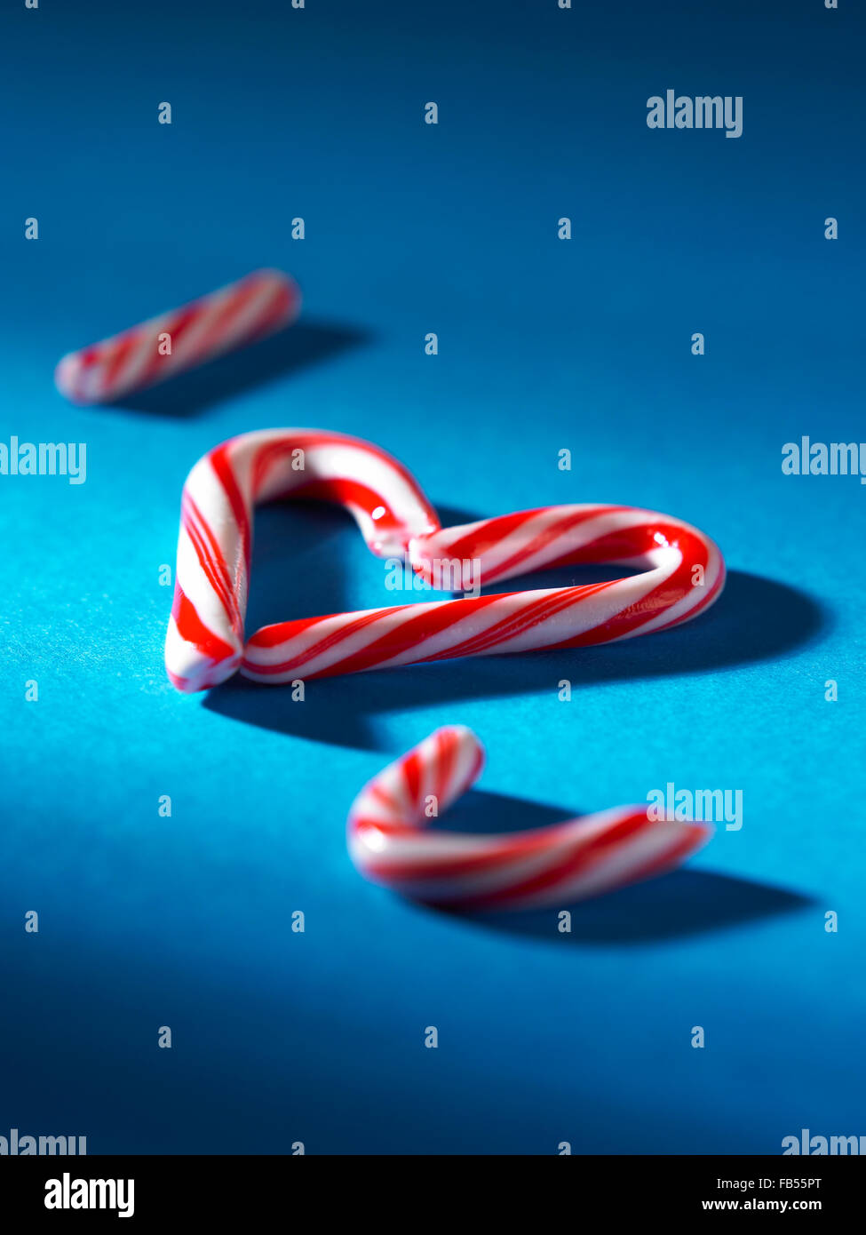 candy cane on the blue color background Stock Photo - Alamy