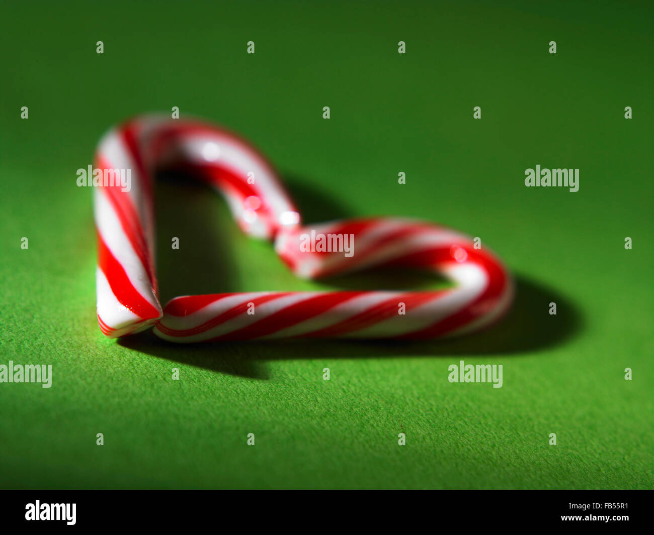 candy cane on the greenn color background Stock Photo - Alamy