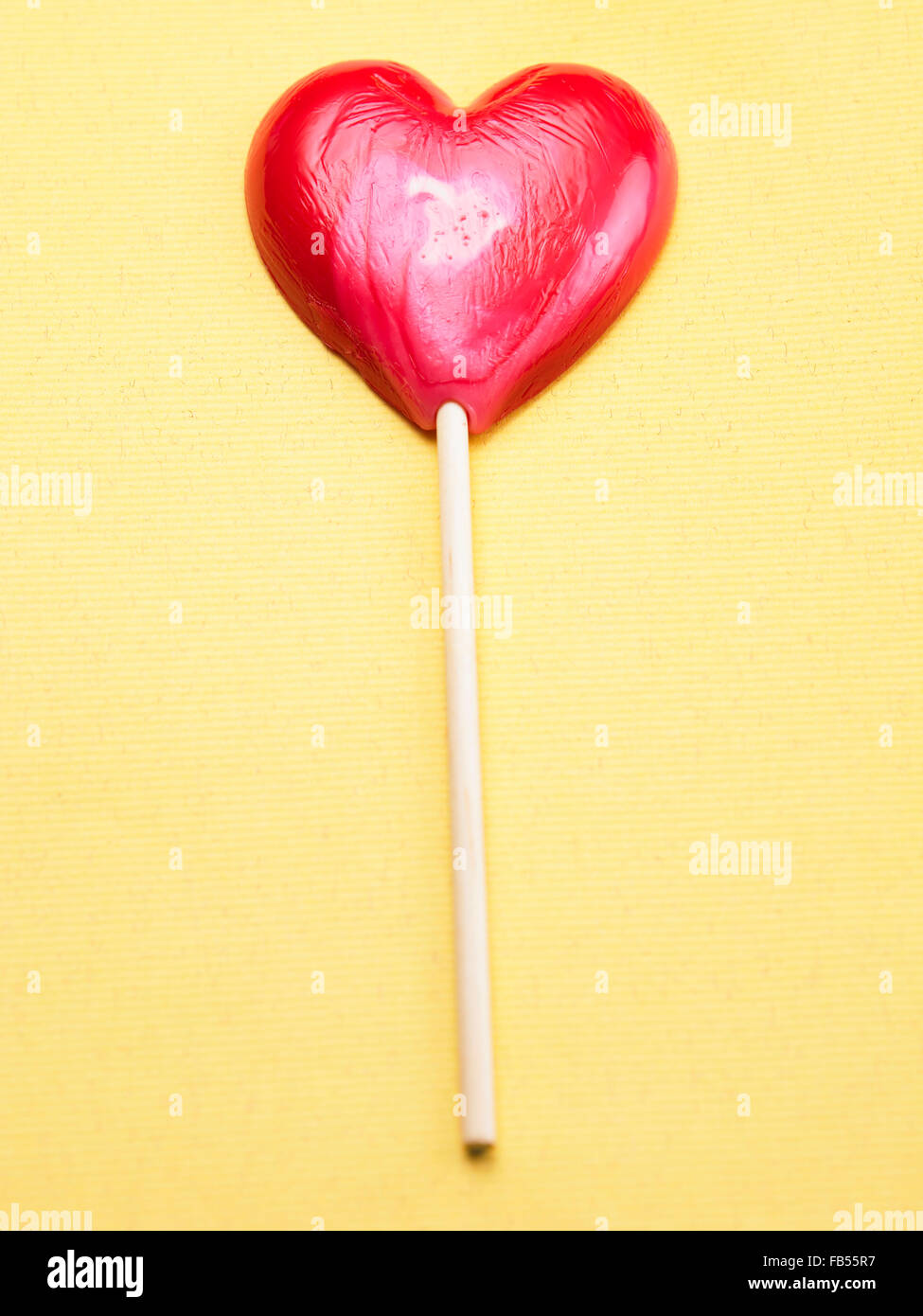 heart shape lollipop on the color background Stock Photo - Alamy