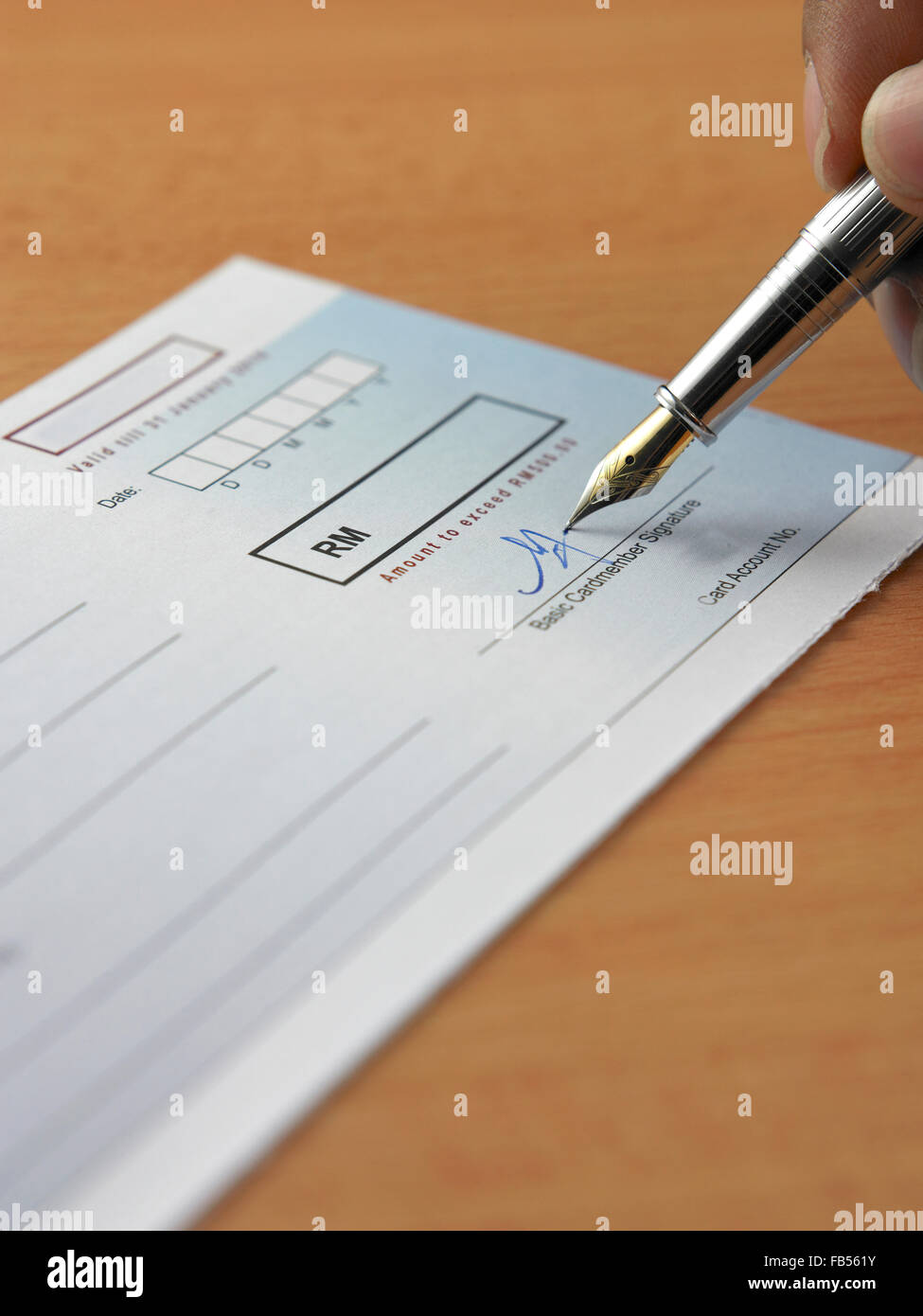 Closeup of a pen on a cheque book on white background Stock Photo - Alamy