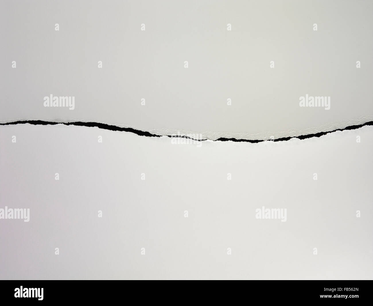 torn or tearing paper into two pieces Stock Photo - Alamy