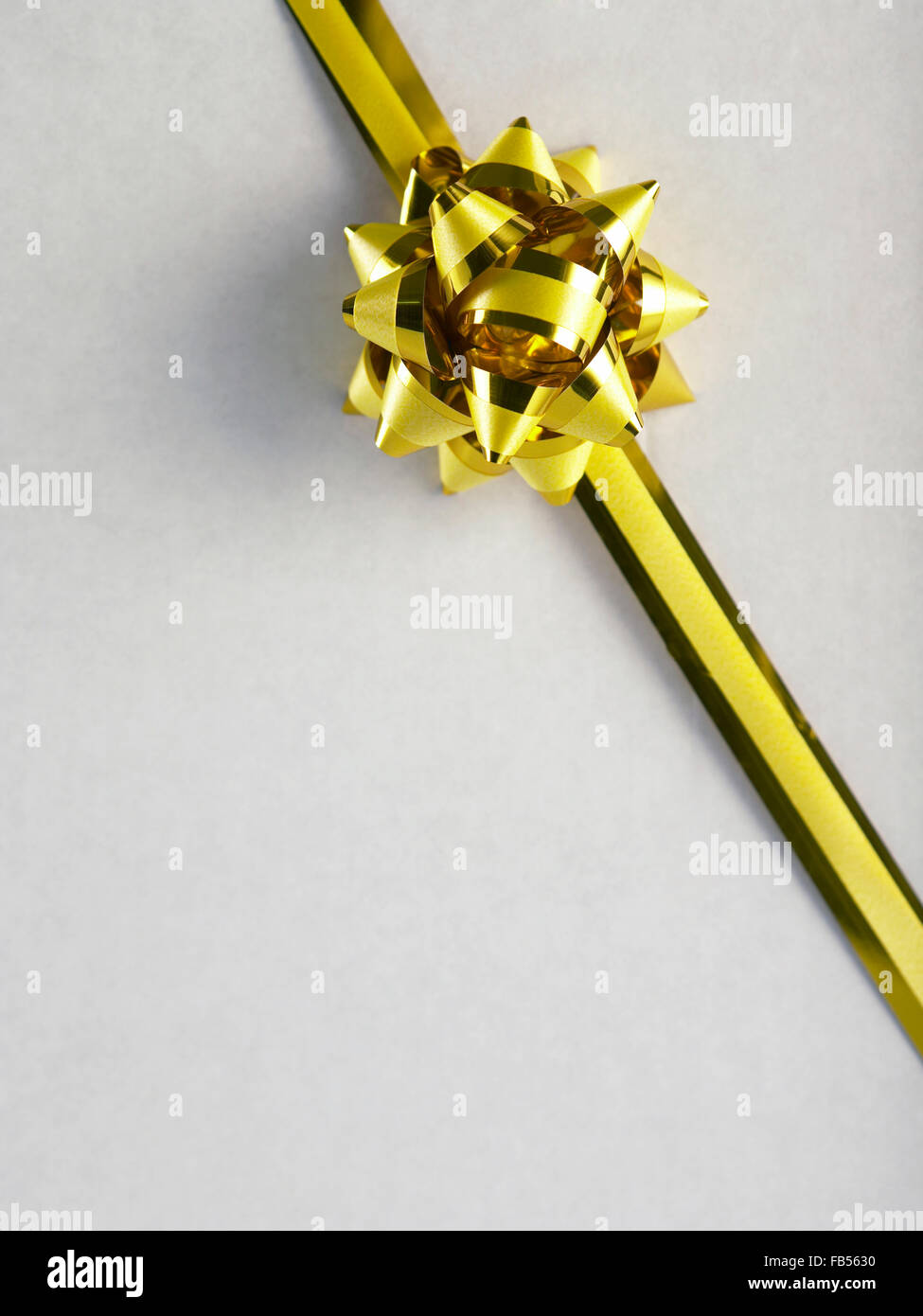 close up the yellow color ribbon on the white box Stock Photo - Alamy