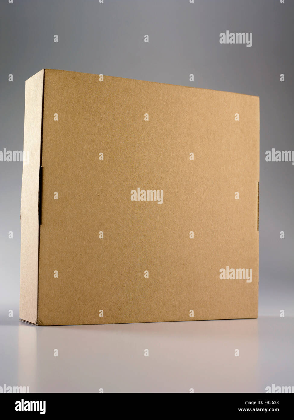 browm color cardboard box on the plain background Stock Photo - Alamy