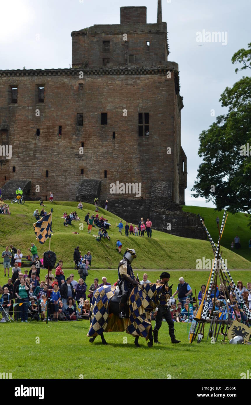 A Medieval knight on horseback and squire at a jousting tournament at ...