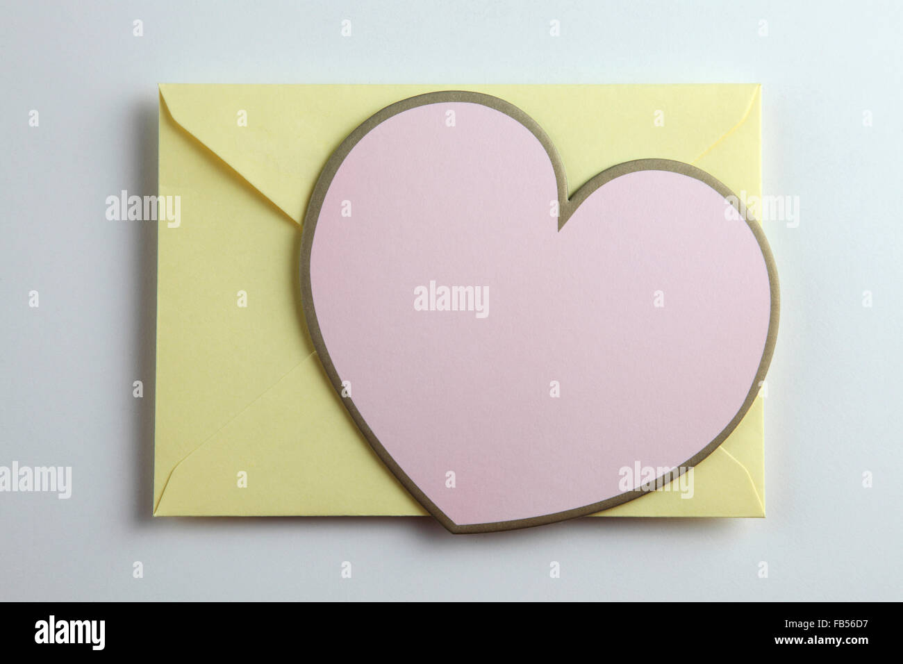 Heart shaped note in envelope onthe plain background Stock Photo - Alamy
