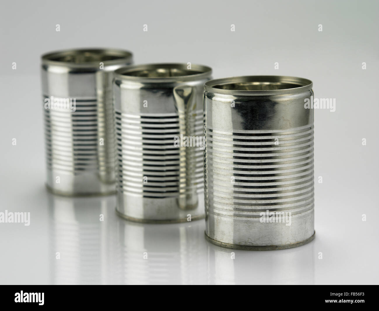 aluminium can in a row on the plain background Stock Photo - Alamy