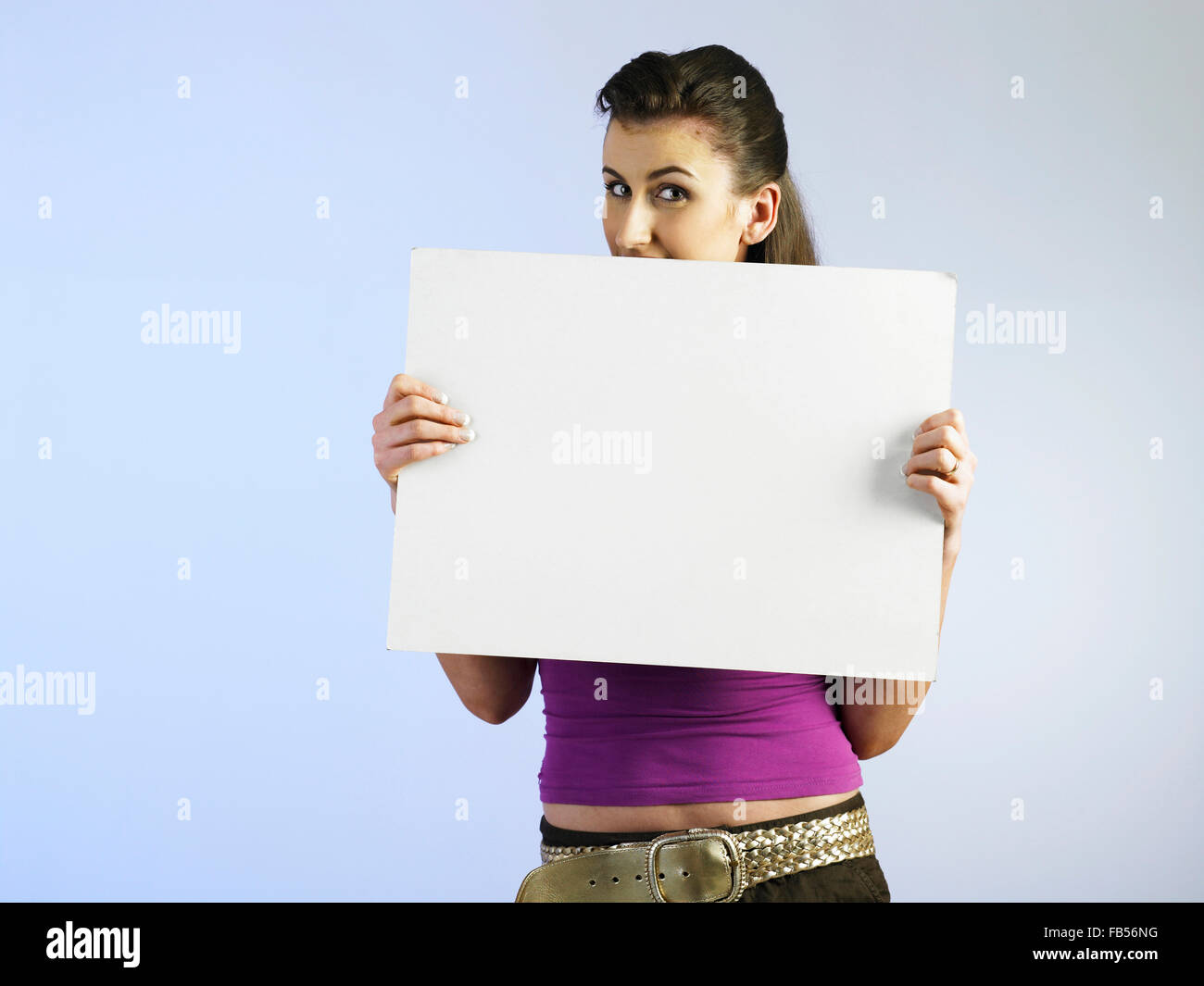 young woman holding a card facing camera Stock Photo - Alamy