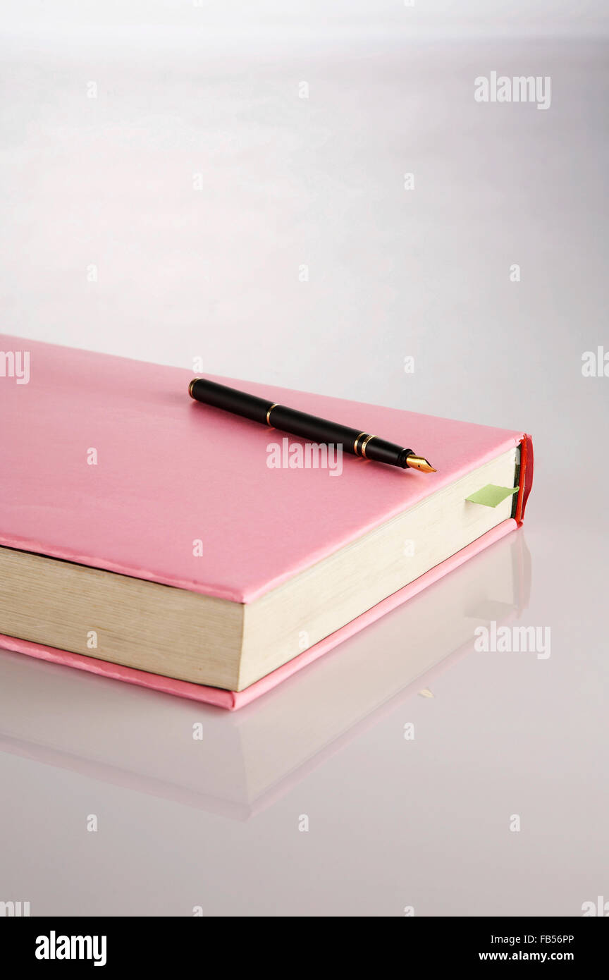 book and pen on white background Stock Photo - Alamy
