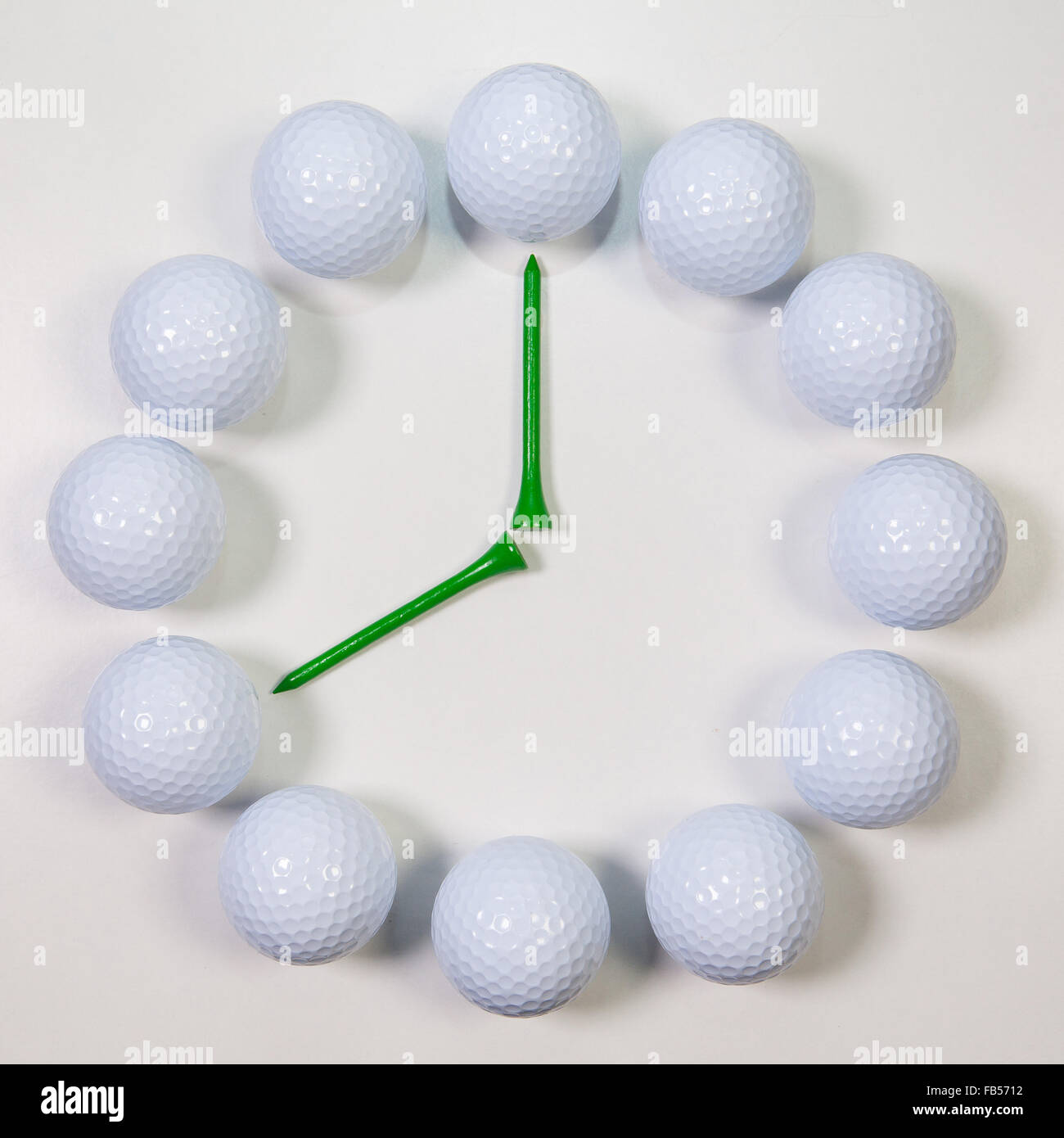 Golf Time - The clock of golf balls and wooden tees Stock Photo - Alamy