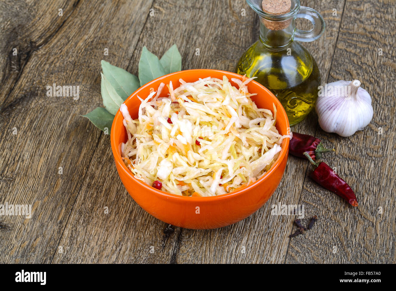 Fermented cabbage - Sauerkraut with herbs and spices on the wood ...