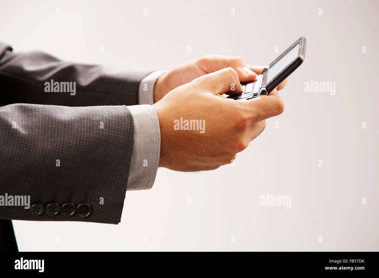 man holding a handphonesending text messages Stock Photo - Alamy
