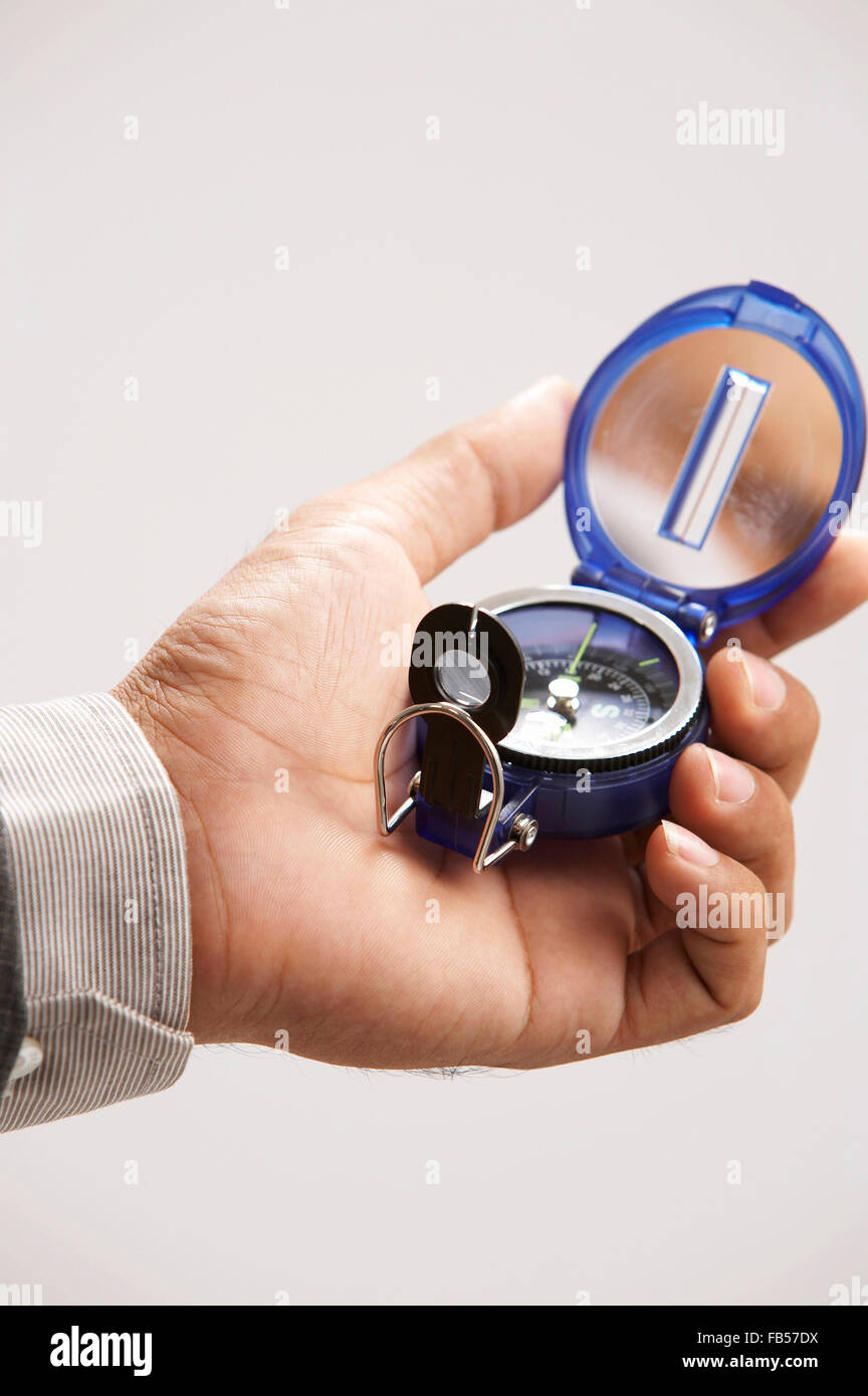 man holding compass seeing which direction to go Stock Photo - Alamy