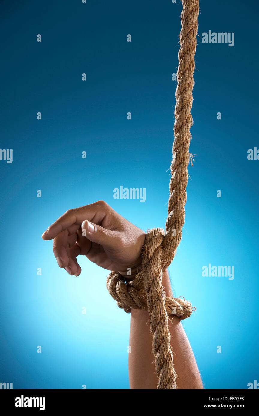 hand being tight by rope asking for help Stock Photo - Alamy
