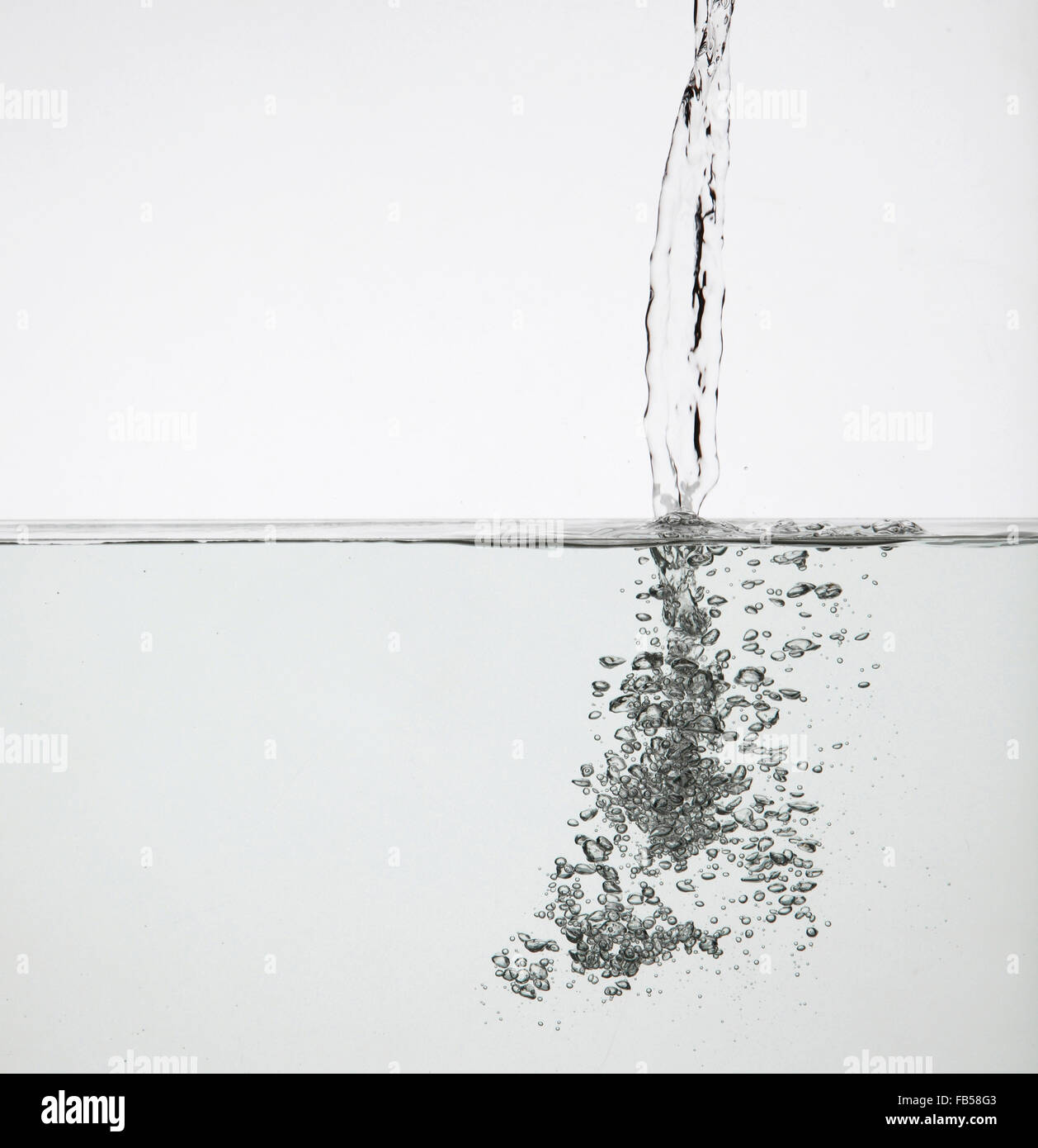 pouring water to a tank with white background Stock Photo - Alamy