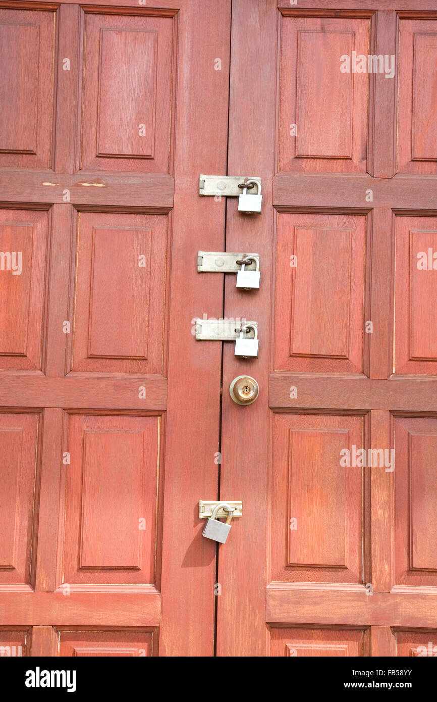 a brown color door with four locks on it Stock Photo - Alamy