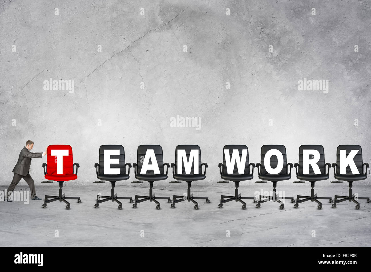 Young businessman pushing word team work Stock Photo - Alamy