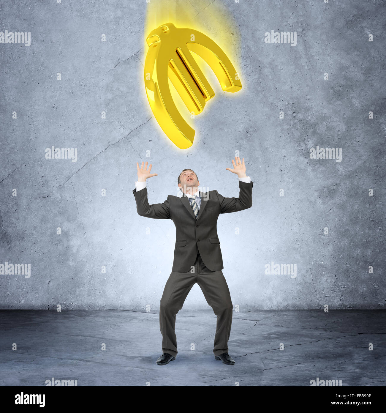 Businessman catching euro sign Stock Photo - Alamy