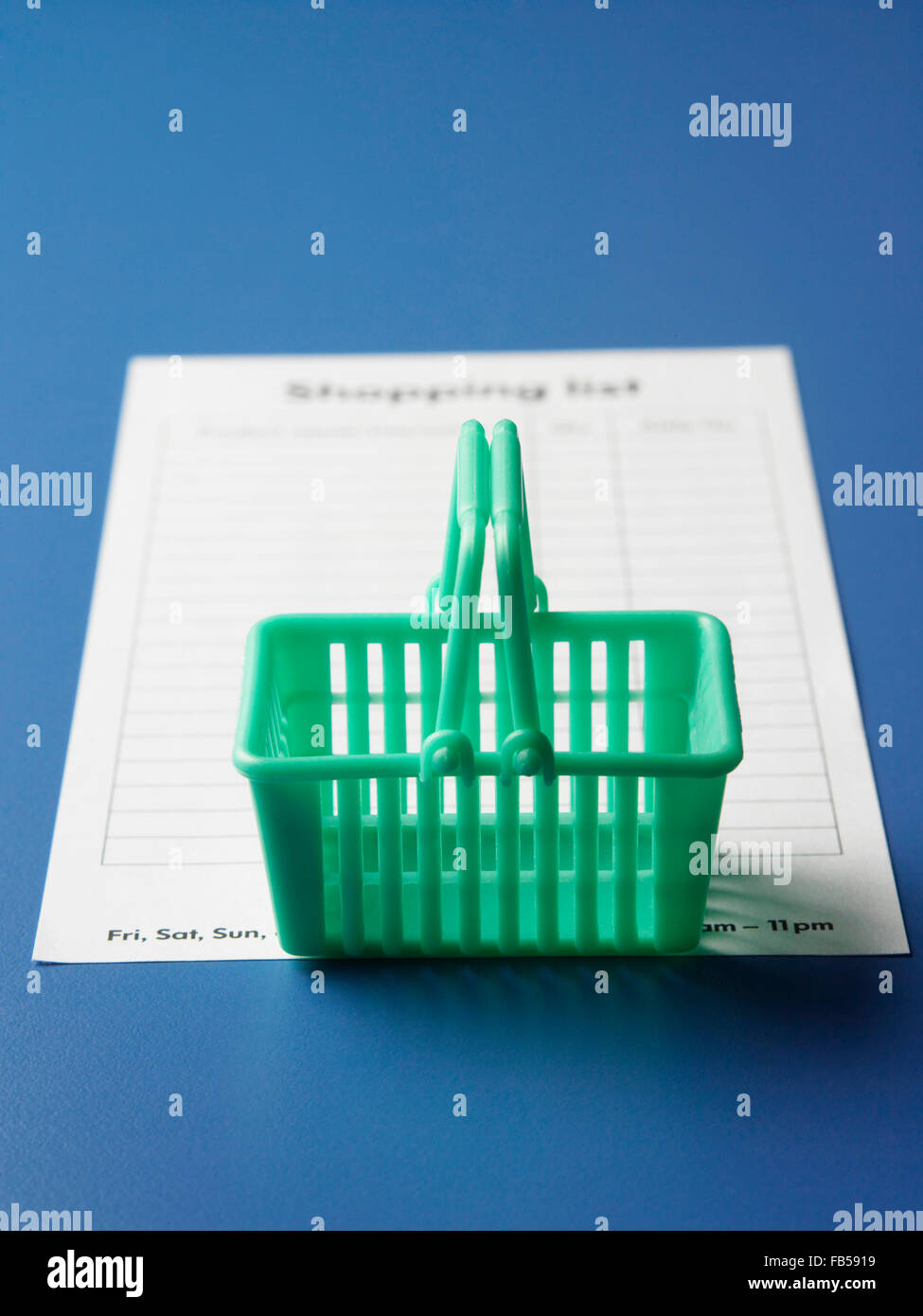 a mini shopping basket and shopping list Stock Photo - Alamy