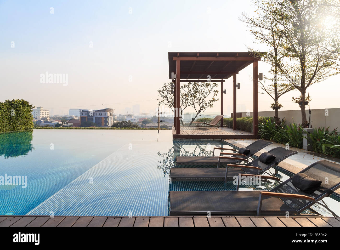 Beach beds alley near and inside swimming pool with sunlight Stock ...