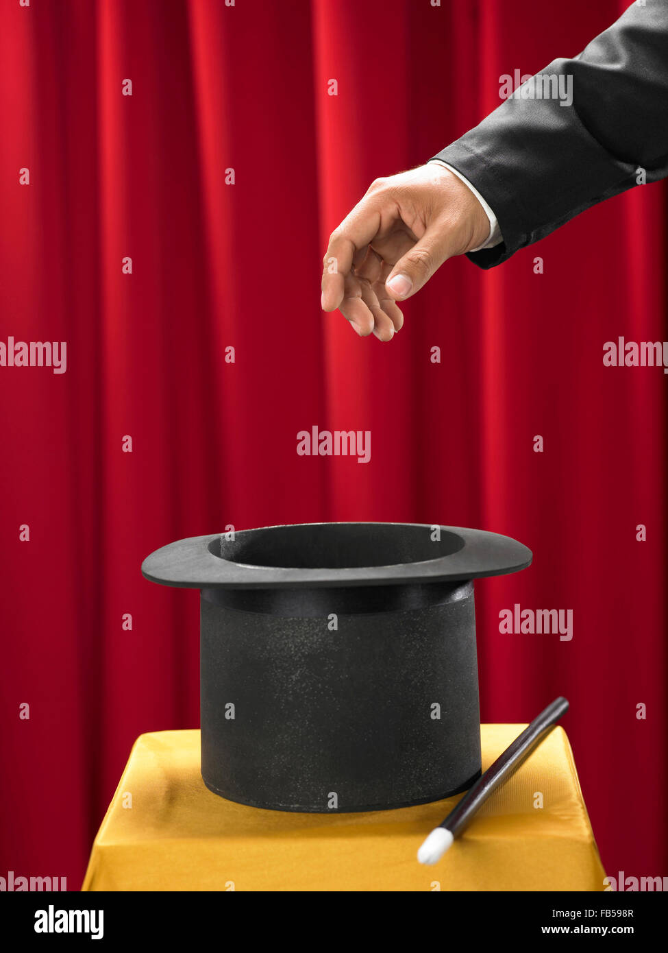 hand going to the black top hat Stock Photo - Alamy