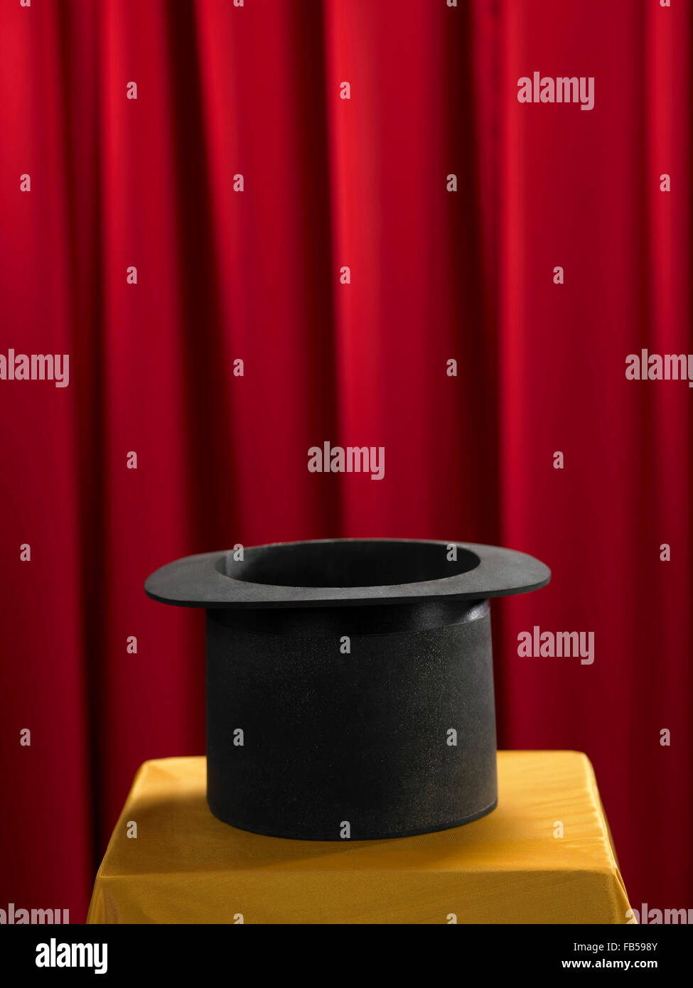 magic top hat on the small table infront of the red curtain Stock Photo ...