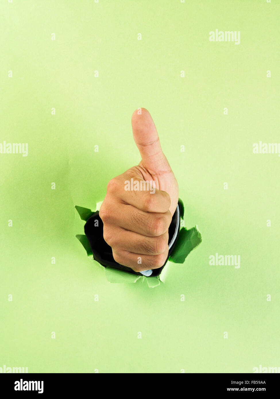 hand gesture break through green paper with action Stock Photo - Alamy