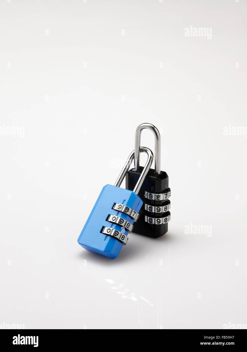 two combination lock together on the plain background Stock Photo - Alamy