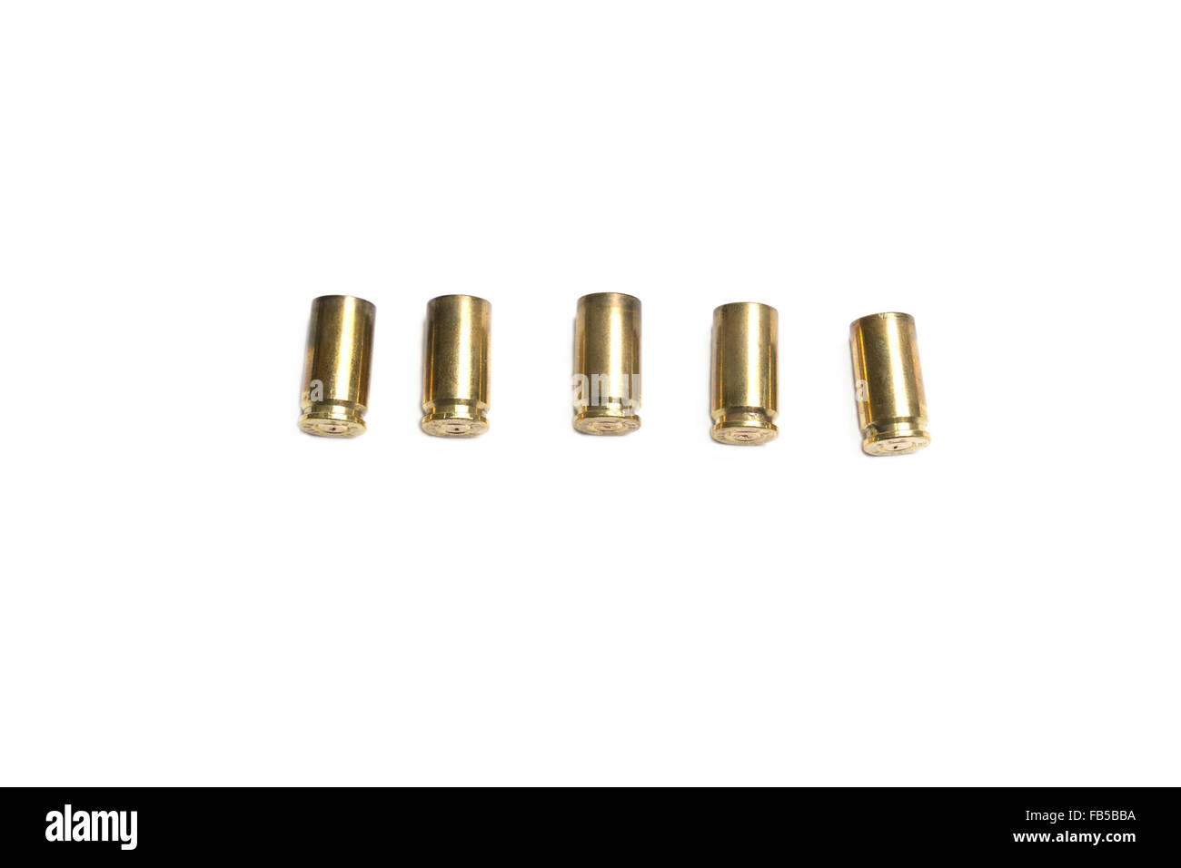 Empty 9mm bullet shells over white background Stock Photo - Alamy