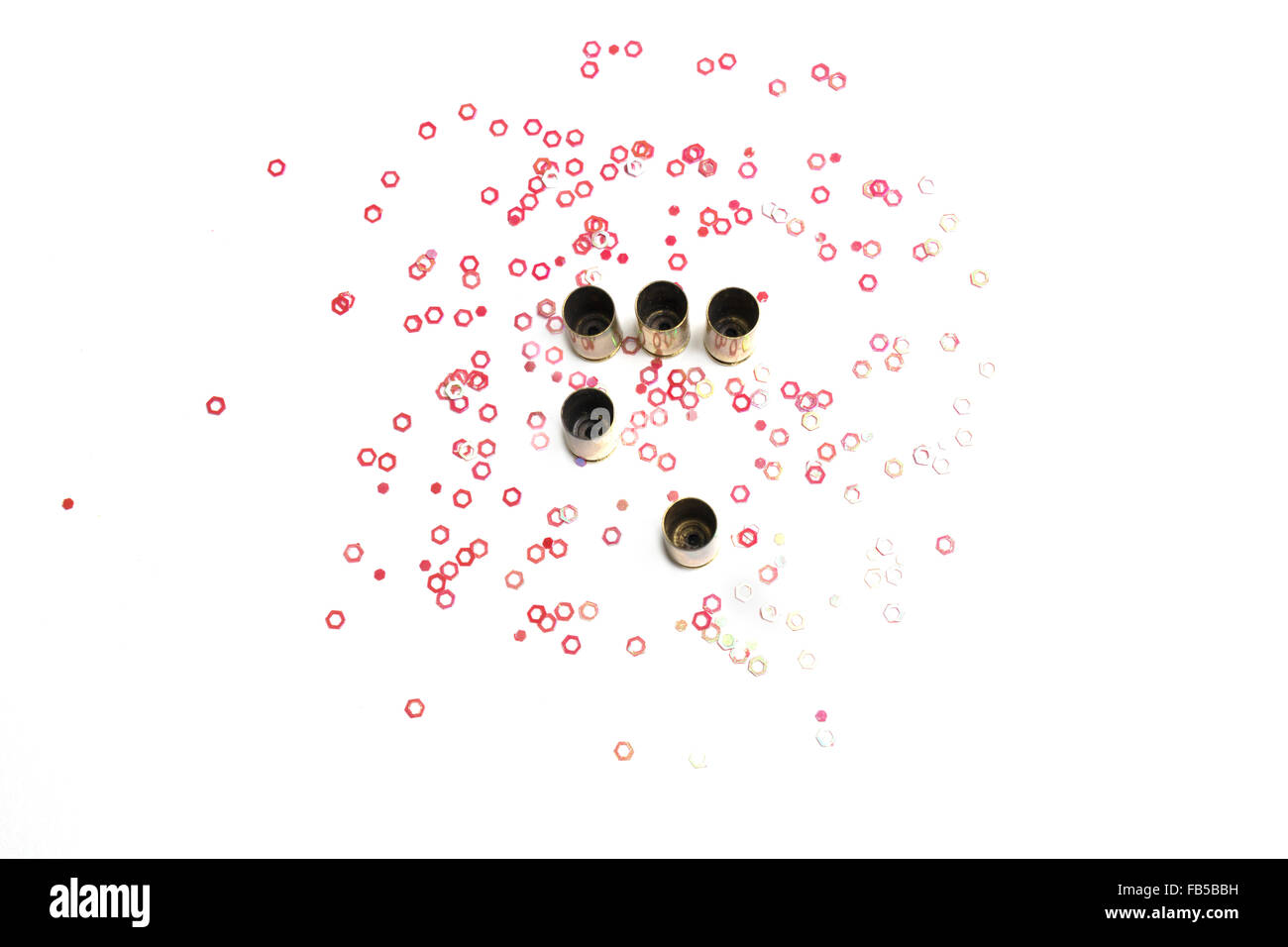 Empty 9mm bullet shells over white background with red hexagon small ...