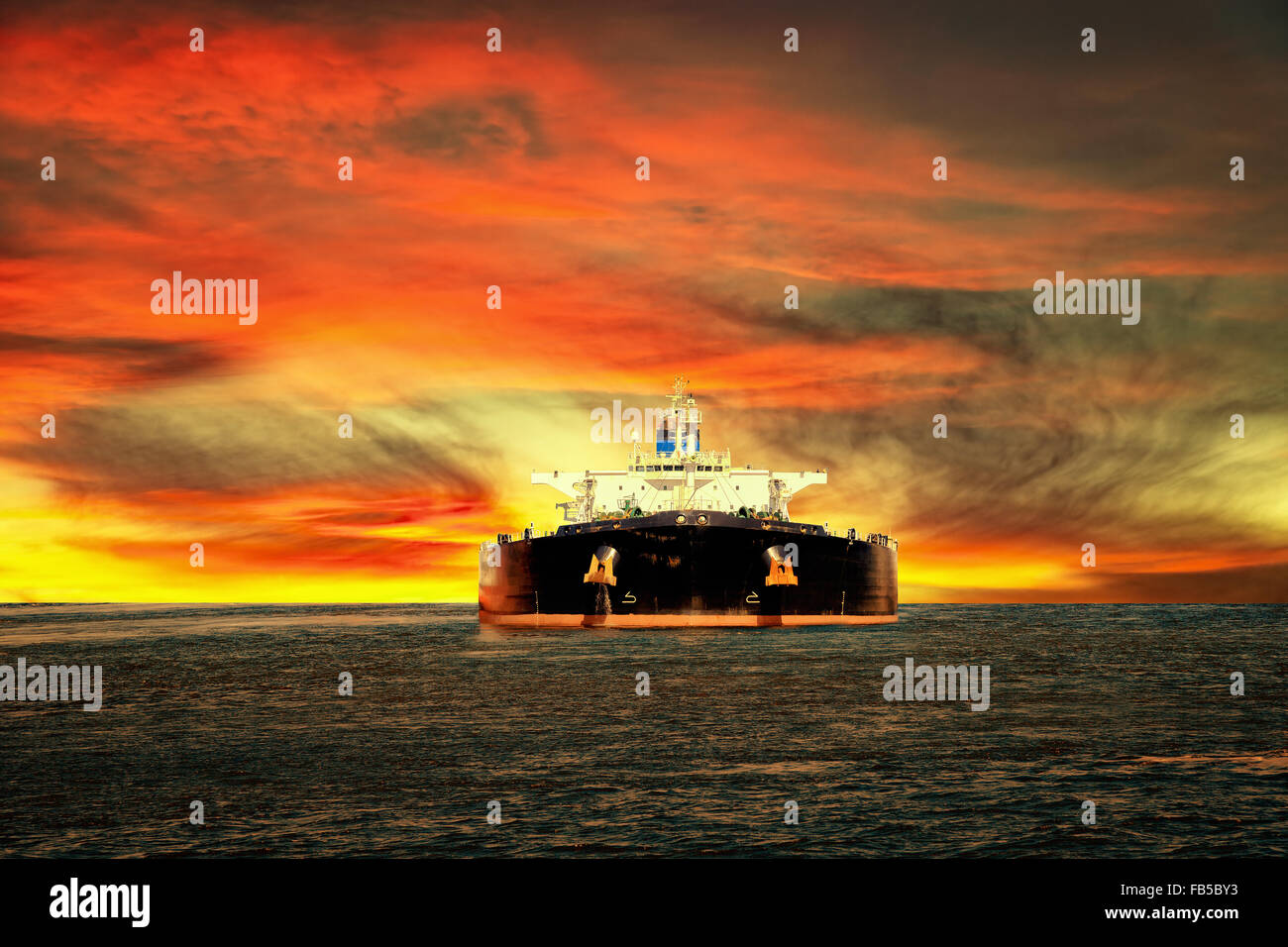 Oil tanker ship at sea on a background of sunset sky Stock Photo - Alamy