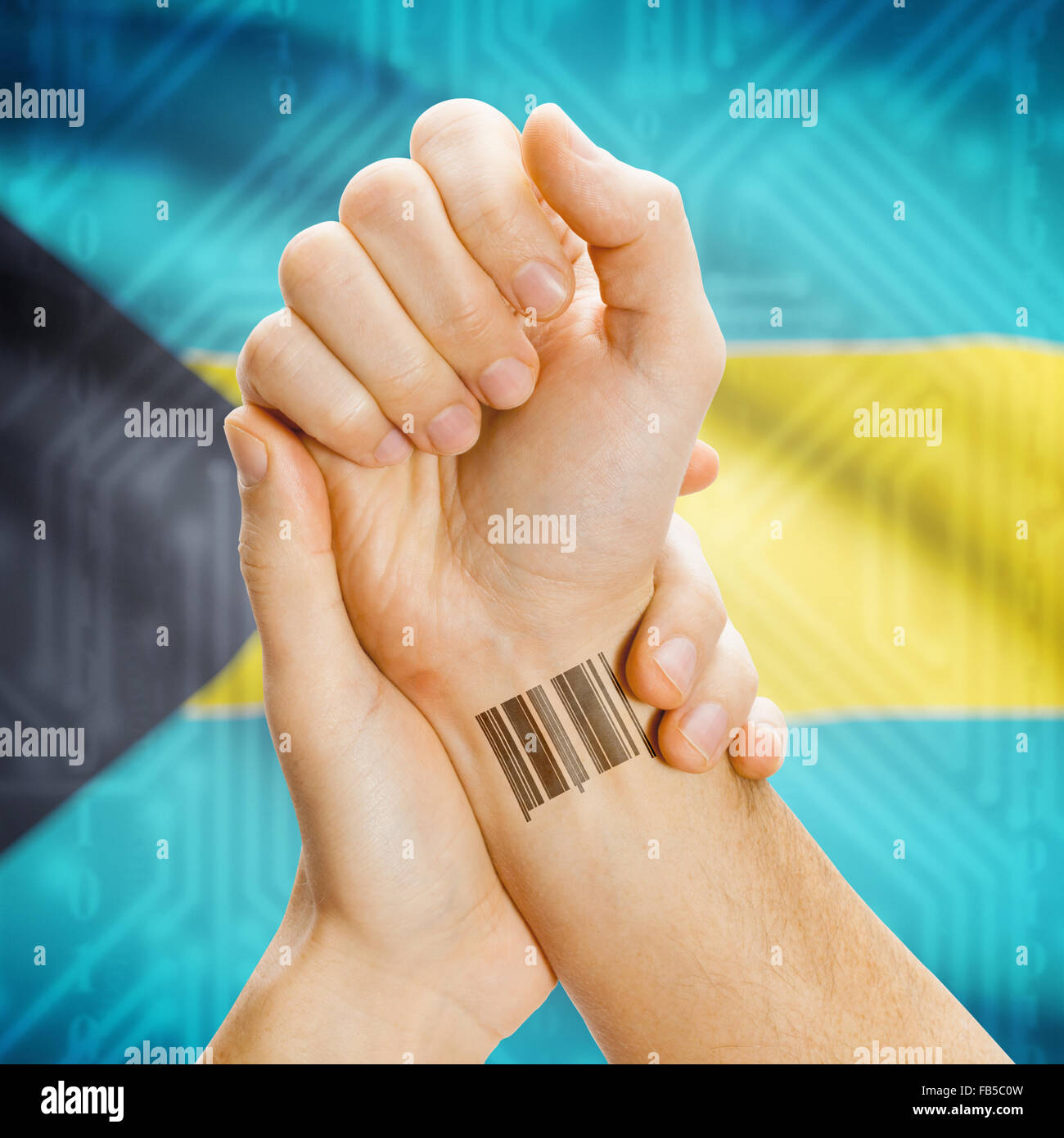 Barcode ID number on wrist of a human and national flag on background ...