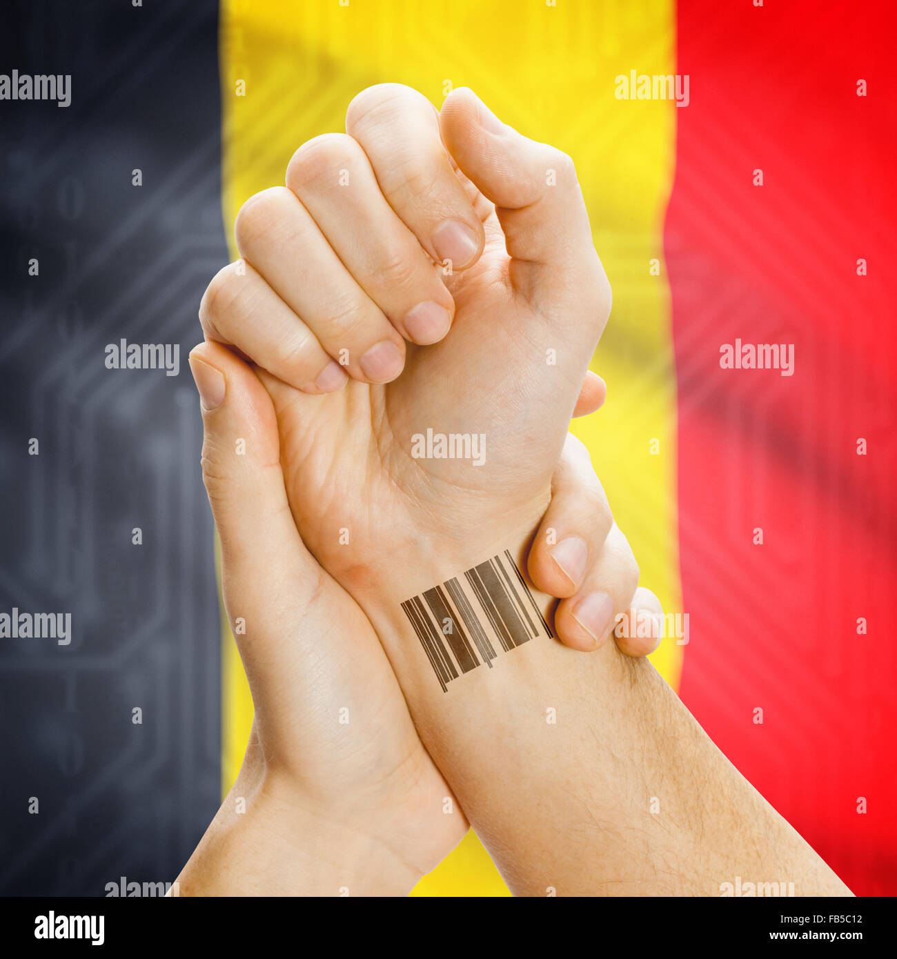 Barcode ID number on wrist of a human and national flag on background ...
