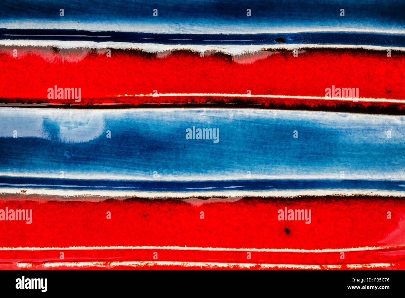 Closeup shot of glazed red and blue ceramics texture Stock Photo - Alamy